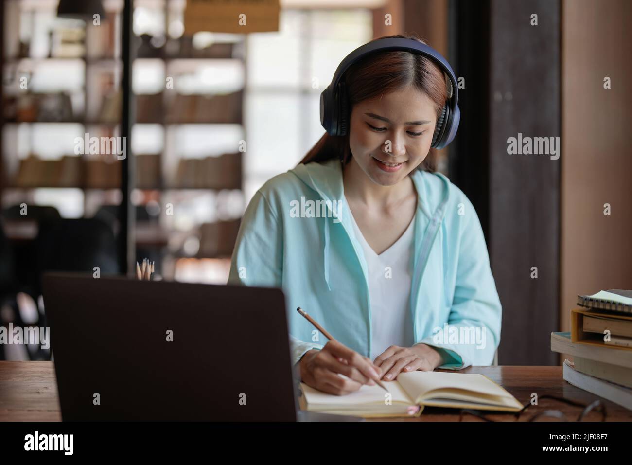 Soft focus of woman writing making list taking notes in notepad working ...