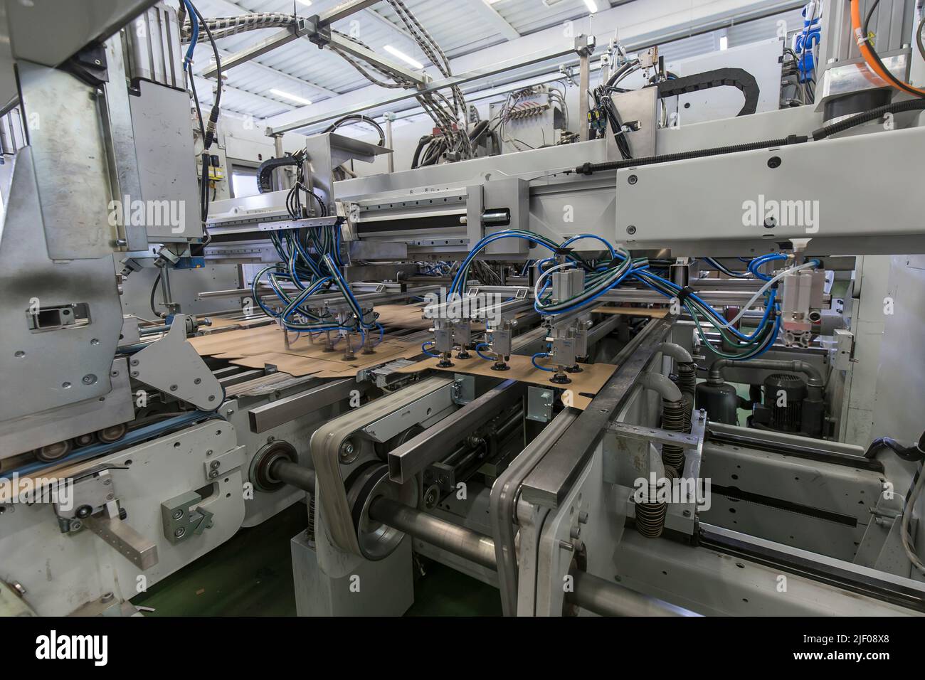 Close up detail of industrial machinery at work in a production line ...