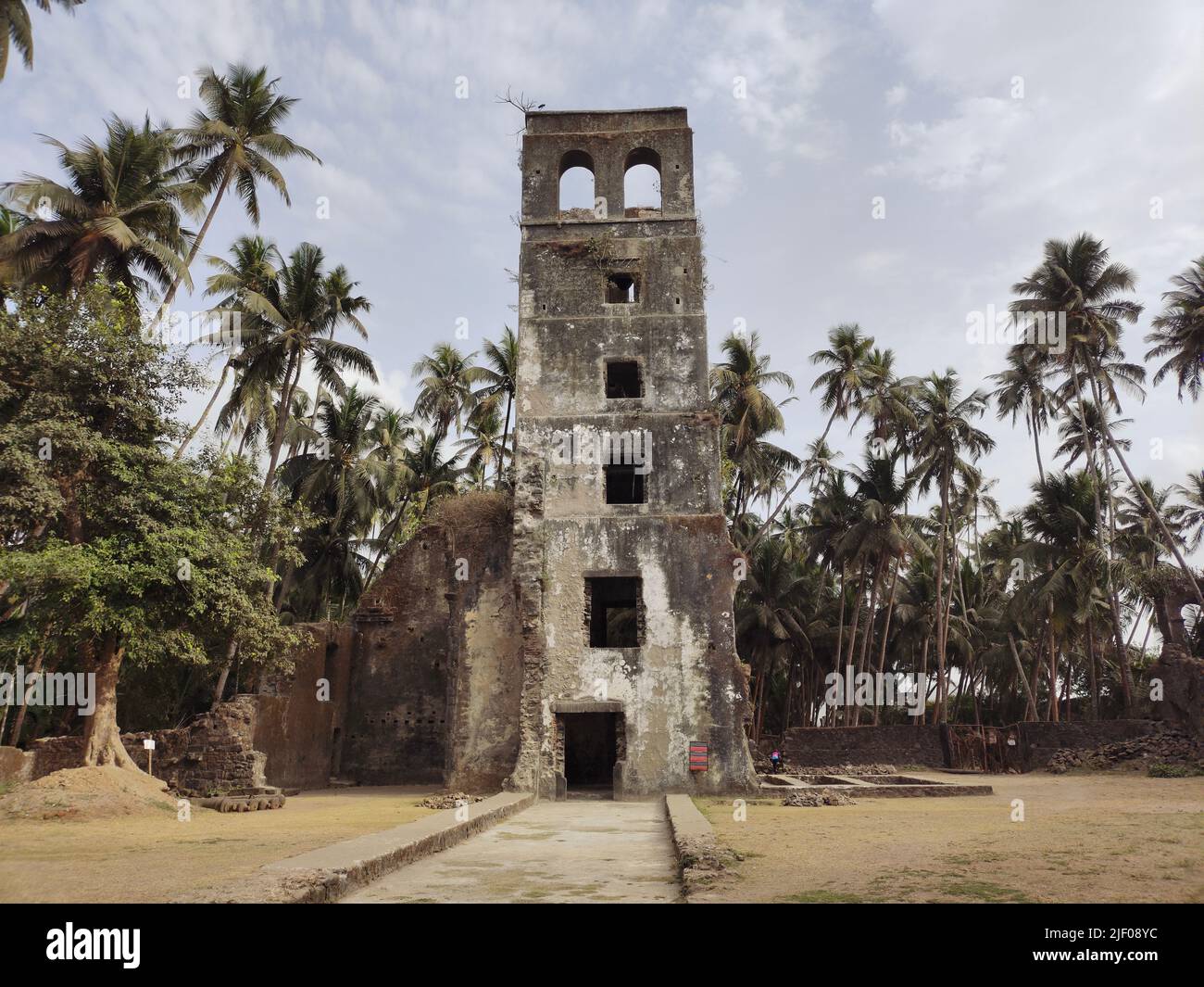 The Revdanda Fort surrounded by tropical trees in Revdanda, India Stock ...