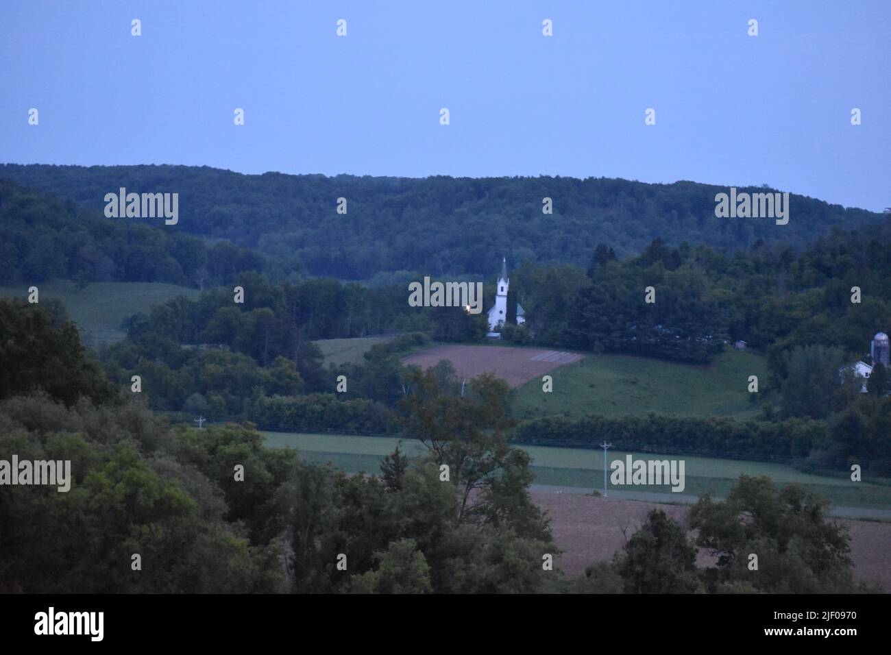 A cathedral visible through trees on a hill in Cashton, Wisconsin Stock ...