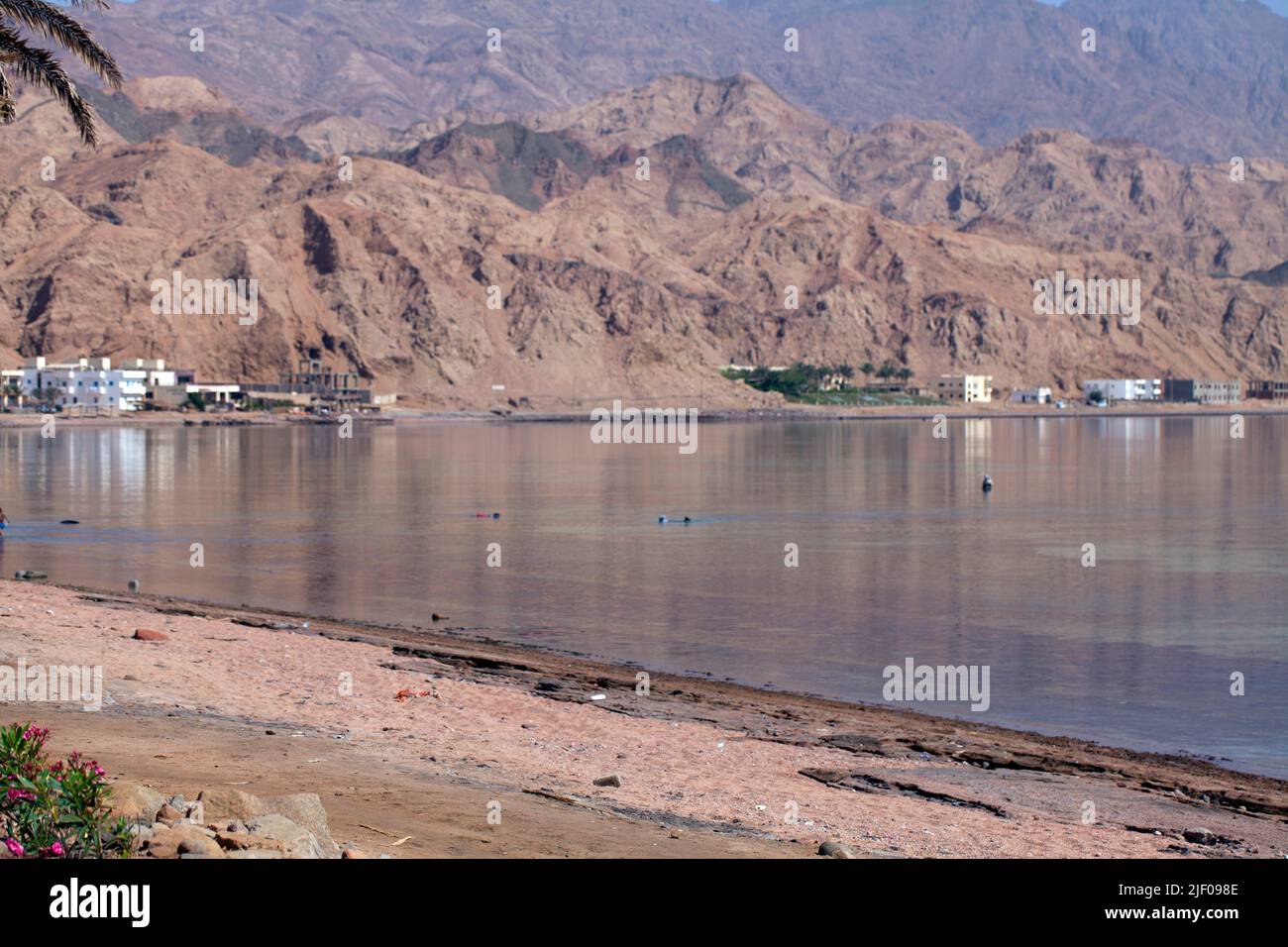 A sunny resort beach at the coast shore of Red Sea in Dahab, Sinai ...