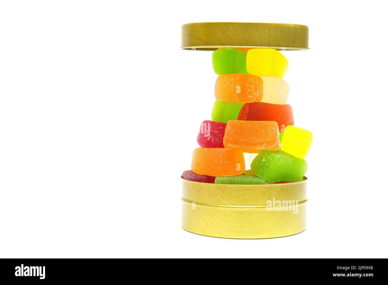 Pyramid made from jelly candies in a round tin box with a lid isolated ...