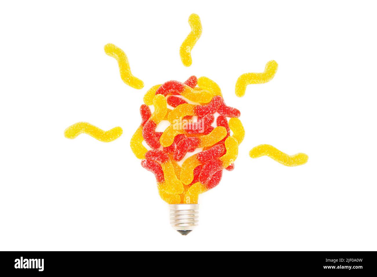 Glowing light bulb symbol made from z-shaped gummy candies isolated on ...