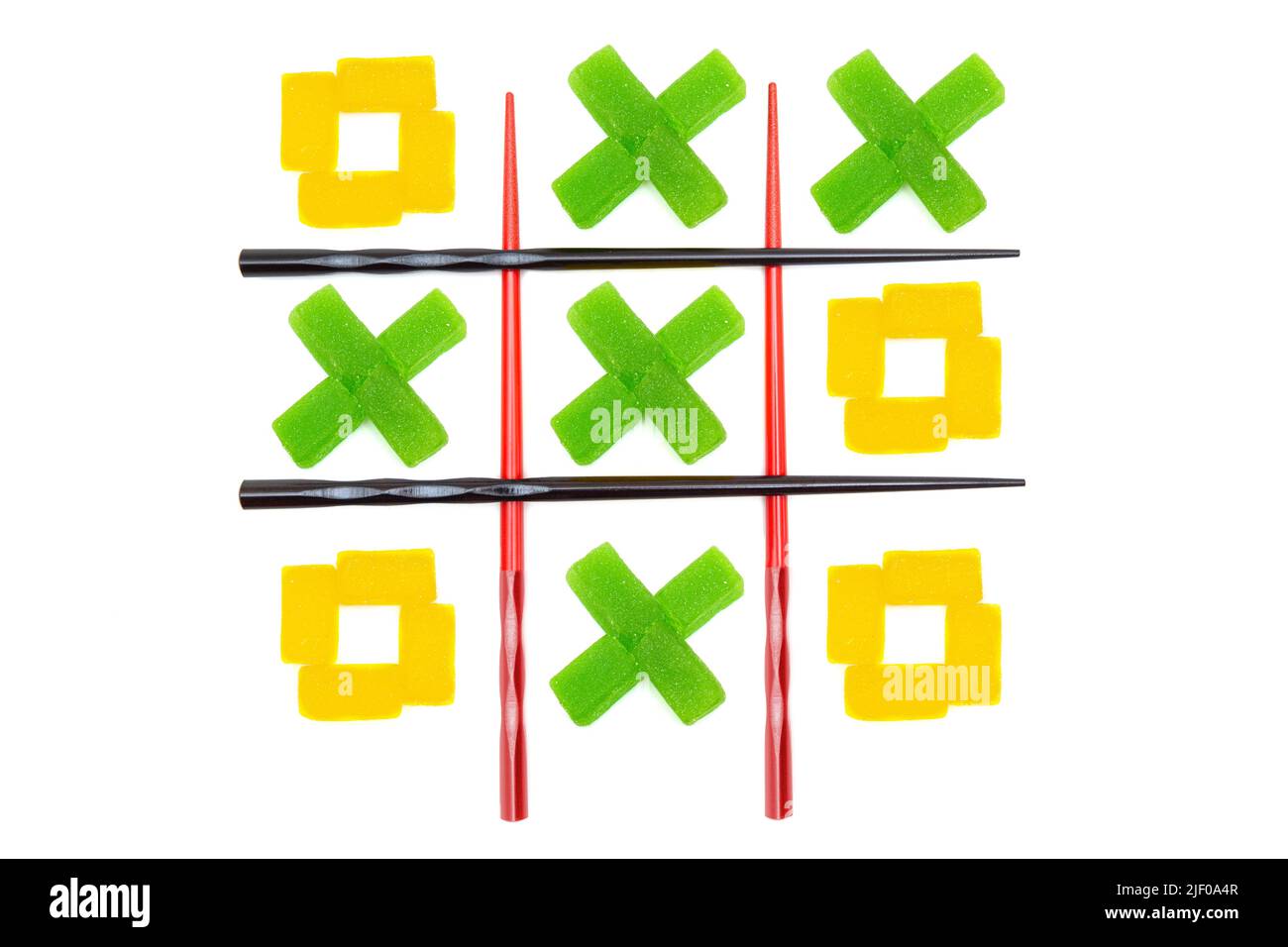 Tic-tac-toe grid made from chopsticks and jelly candies isolated on ...