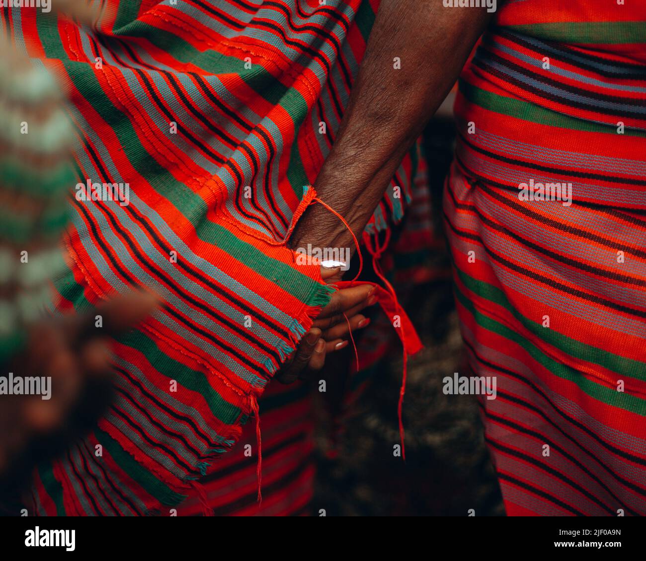 A closeup shot of women wearing African traditional clothes and holding ...