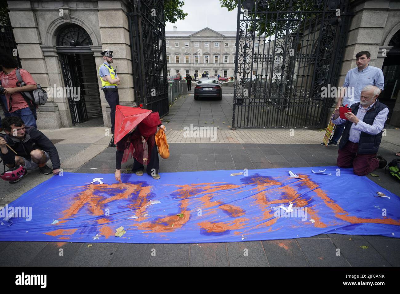 Melina Sharp (centre left) pretends to pour bauxite into the Shannon ...