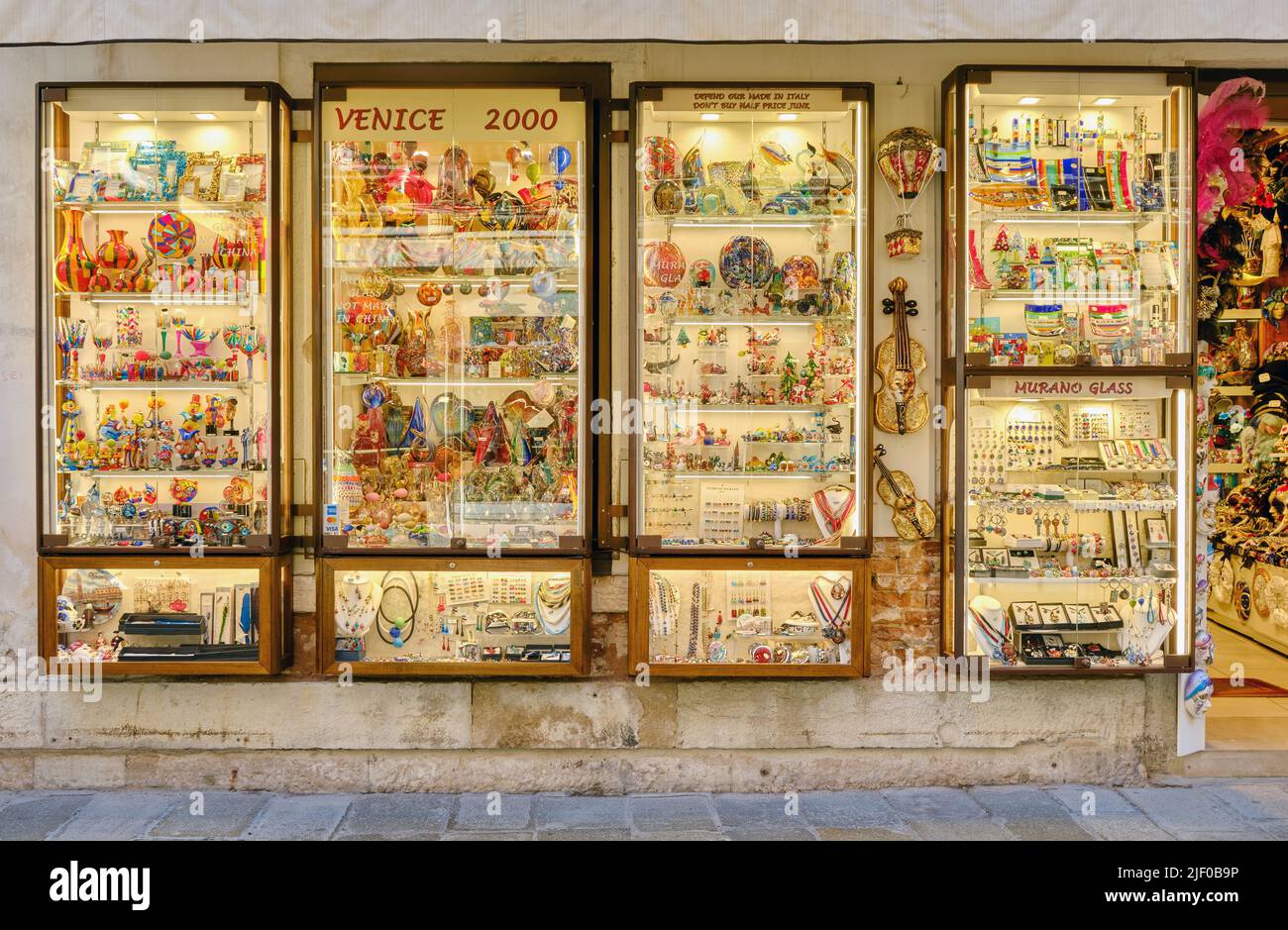 Window display of typical illuminated souvenir and gift shop in Venice ...