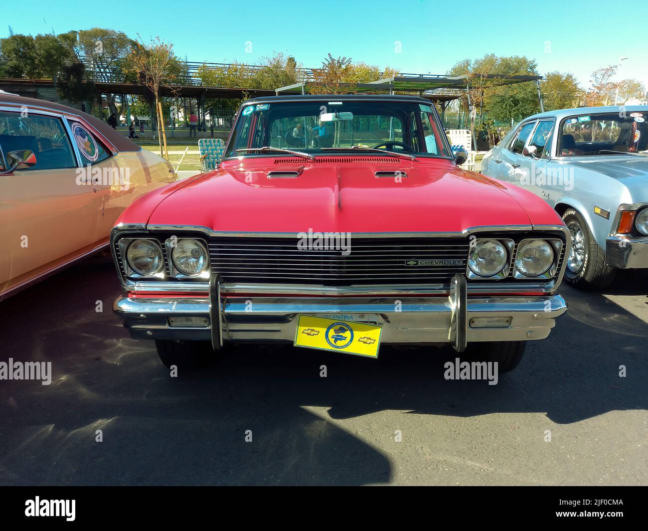 Old red Chevrolet 400 Super four door sedan 1969 - 1974 by GM in a park ...