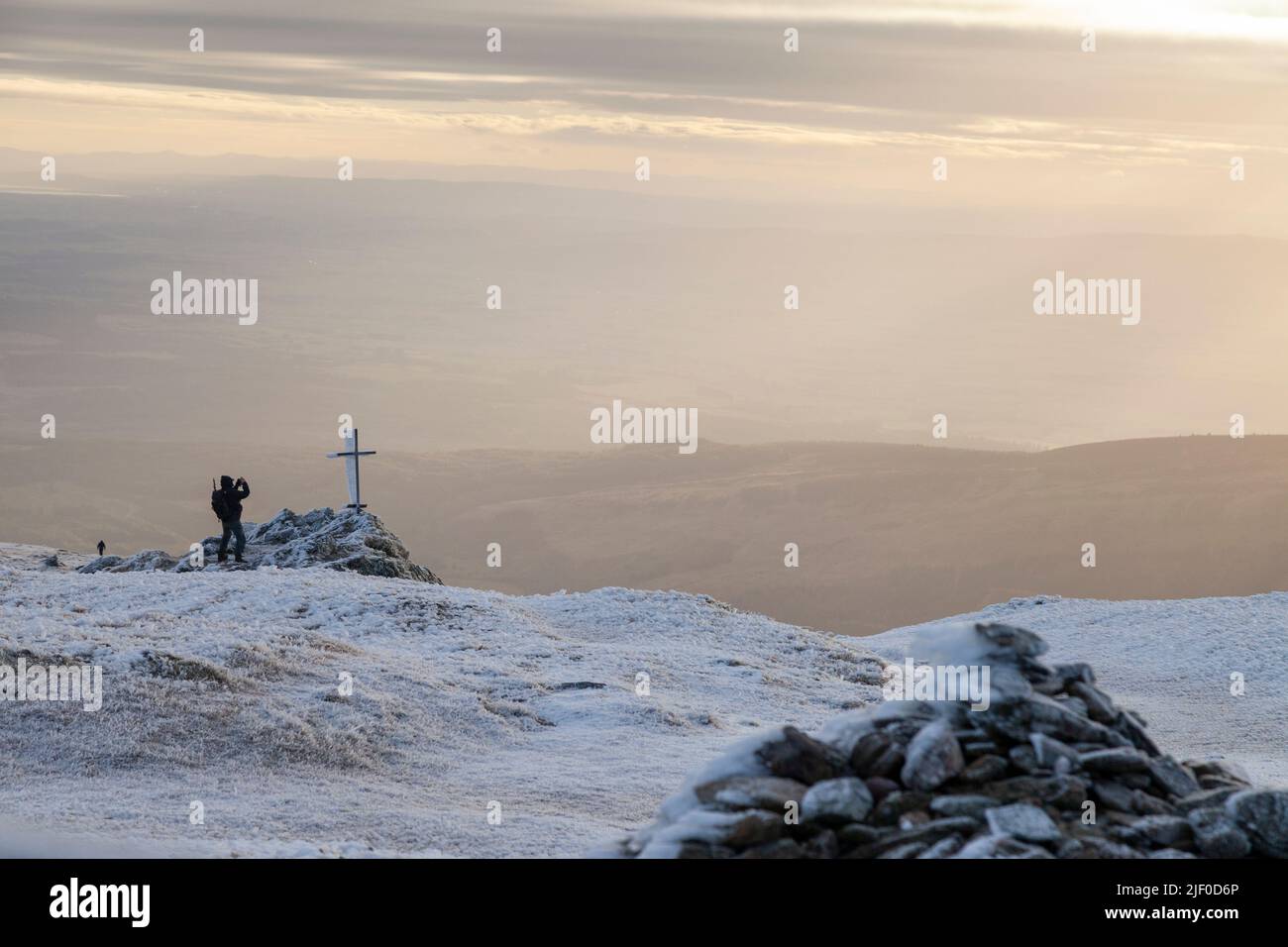 walkers near the Iron Cross memorial near the summit of Ben Ledi ...