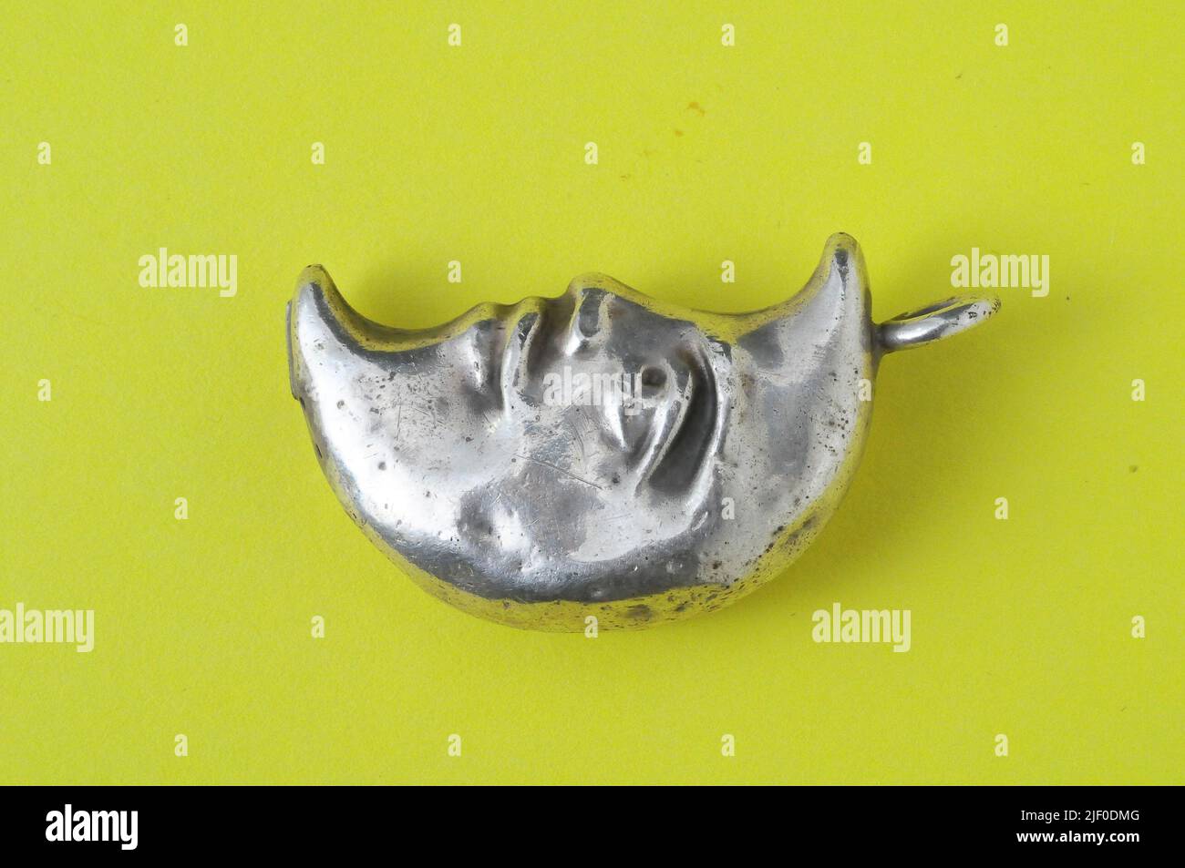Half Moon Silver Jewel over a Colored Background Stock Photo - Alamy