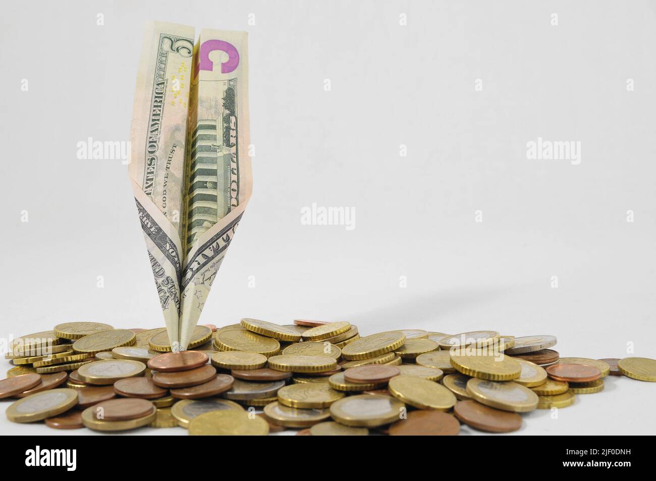 Flying Money Concept a Dollar Airplane and Coins Stock Photo - Alamy
