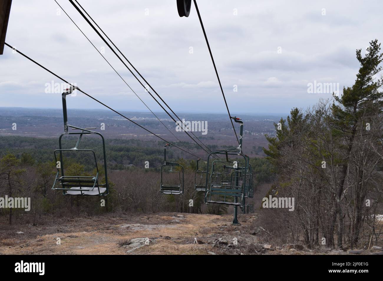 A scenic view of a ropeway in a forest in cloudy sky background Stock ...