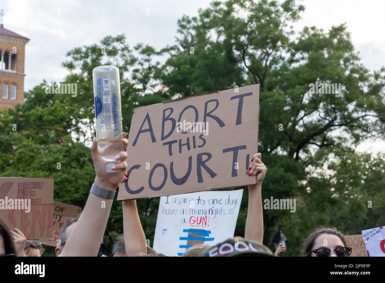 A crowd of protesters holding cardboard signs after the Supreme Court ...