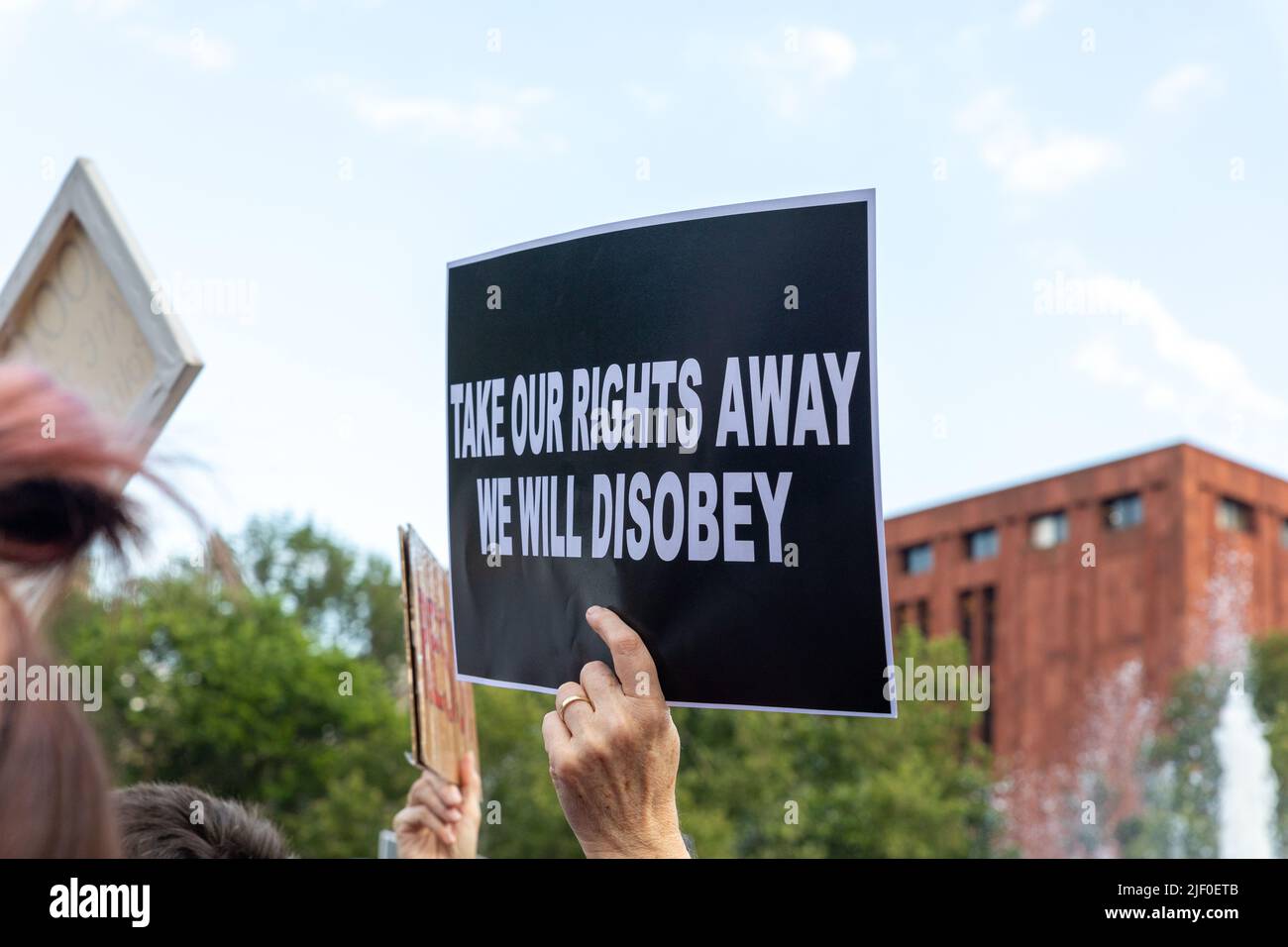 A crowd of protesters holding demonstration signs after the Supreme ...