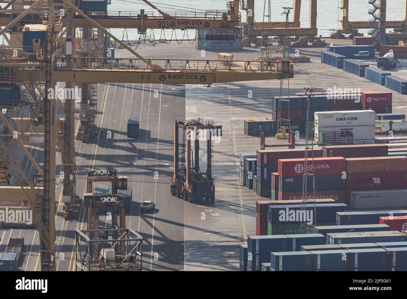 Heavy duty cranes on the port lifting containers. Sisu Stock Photo - Alamy