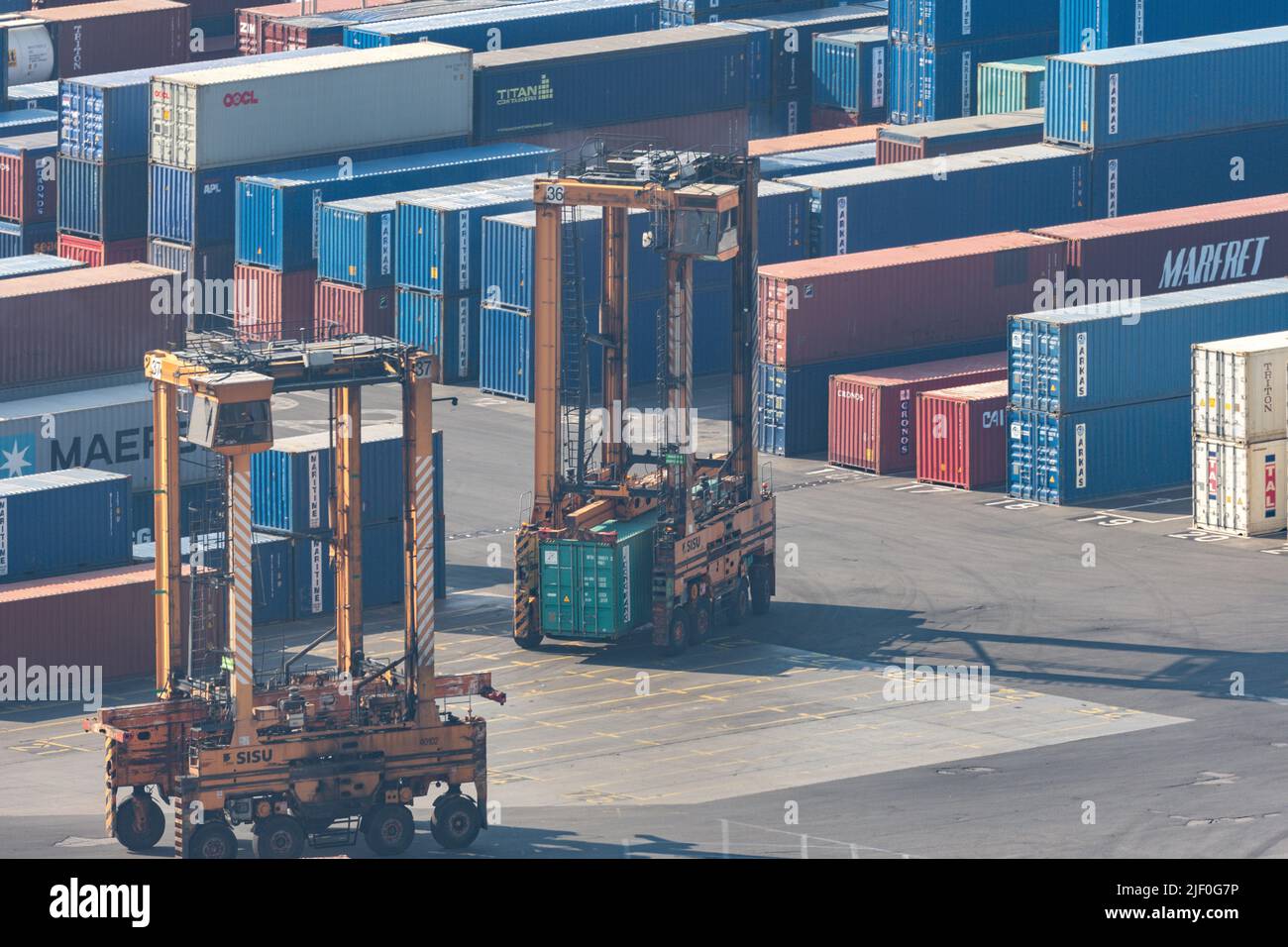 Heavy duty cranes on the port lifting containers. Sisu Stock Photo - Alamy