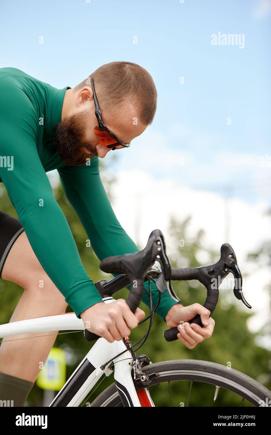 A cyclist in motion. Bike ride along the embankment along the river ...