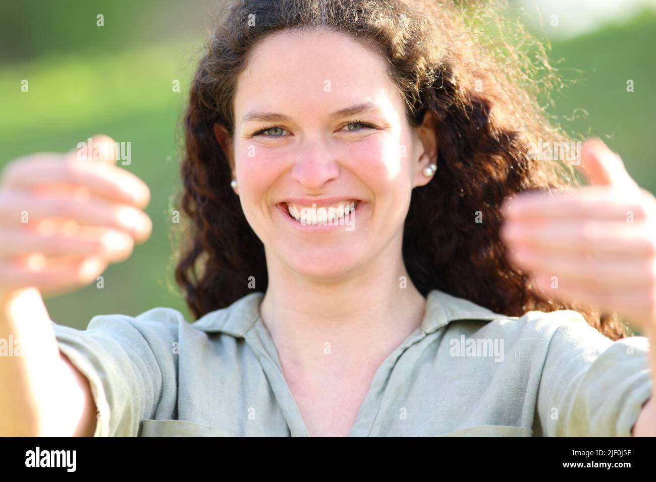 Front view portrait of a happy woman gesturing come here with both ...