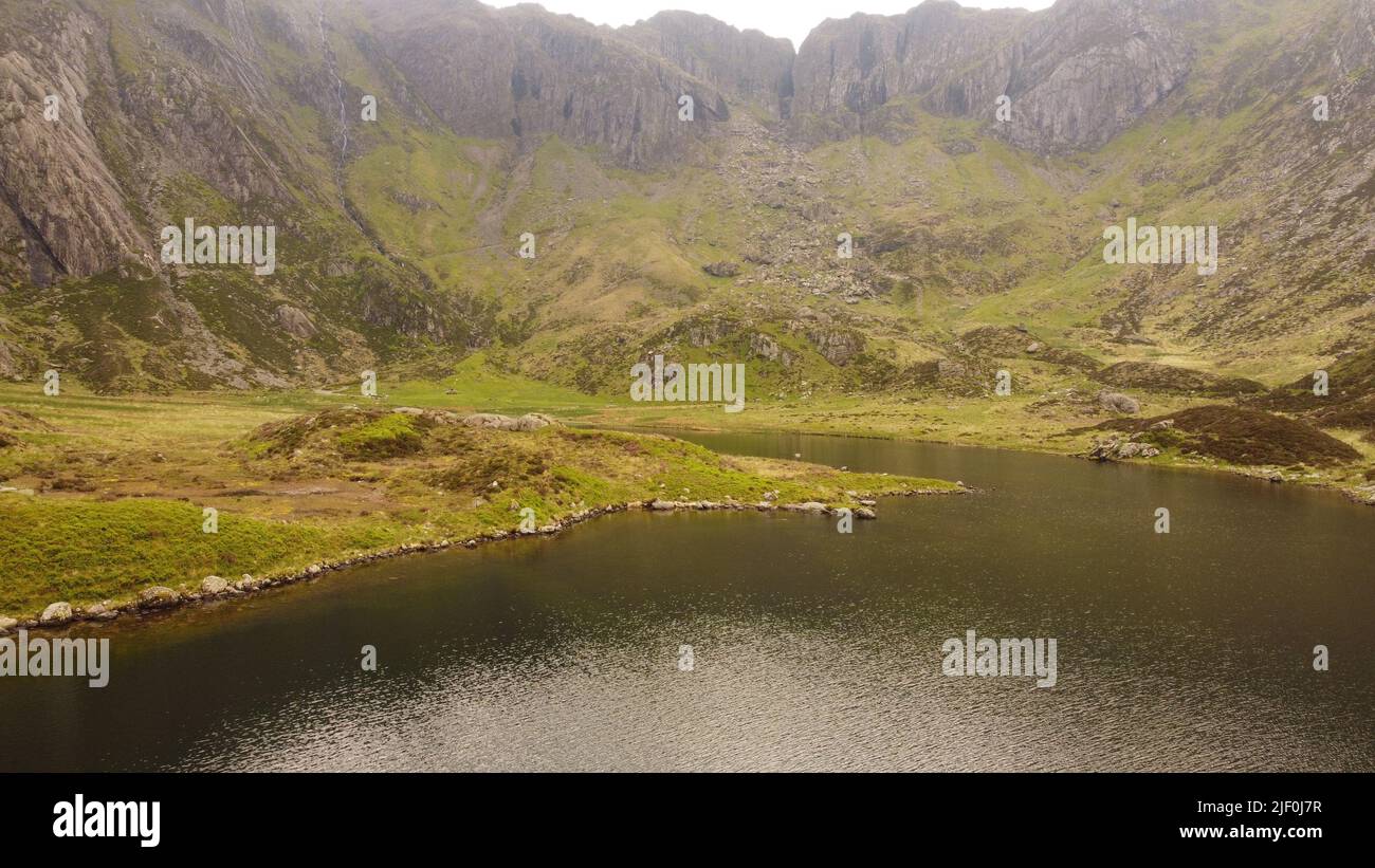 The Llyn Idwal lake surrounded by rocky mountains in Snowdonia National ...