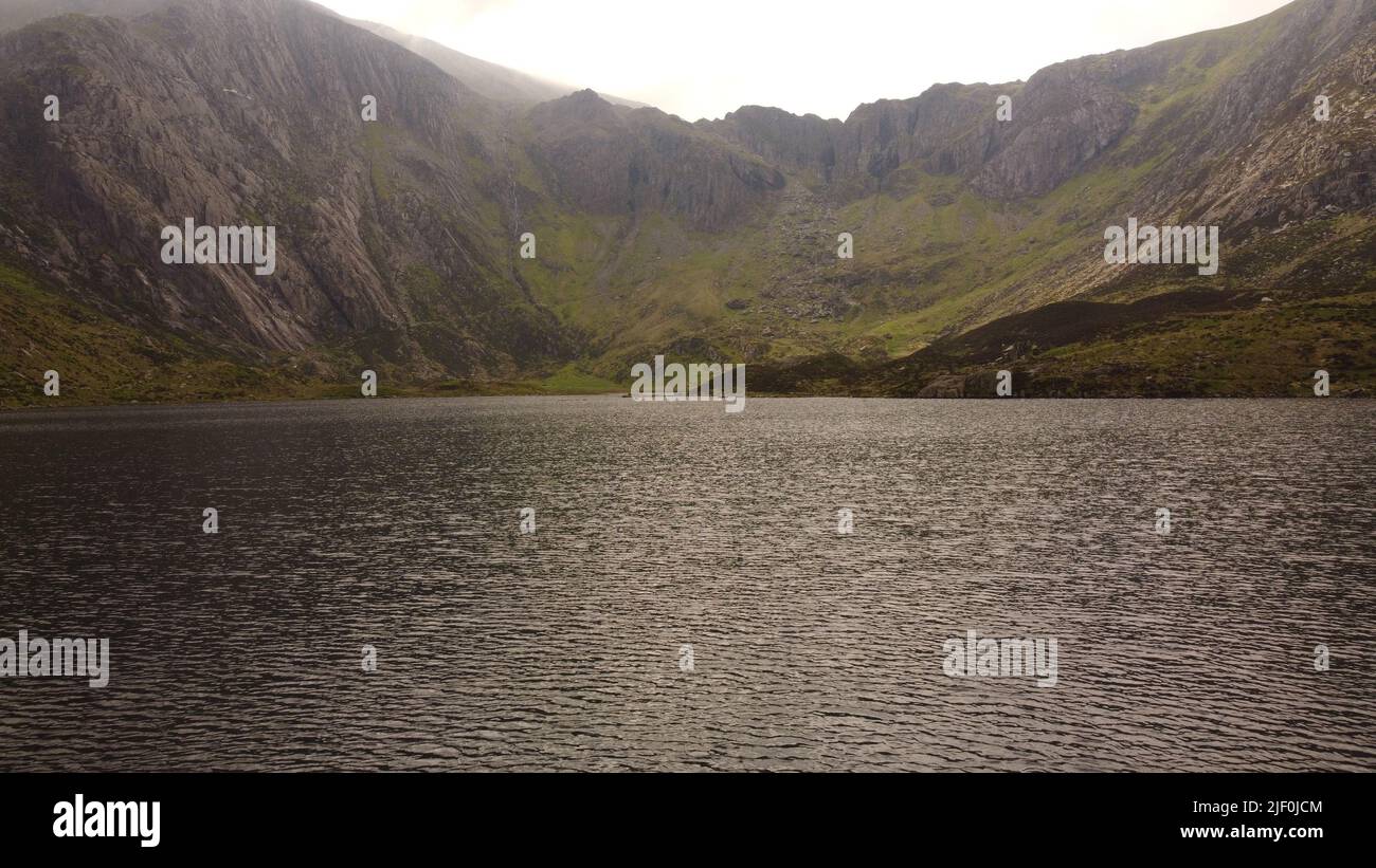 The Llyn Idwal lake surrounded by rocky mountains in Snowdonia National ...