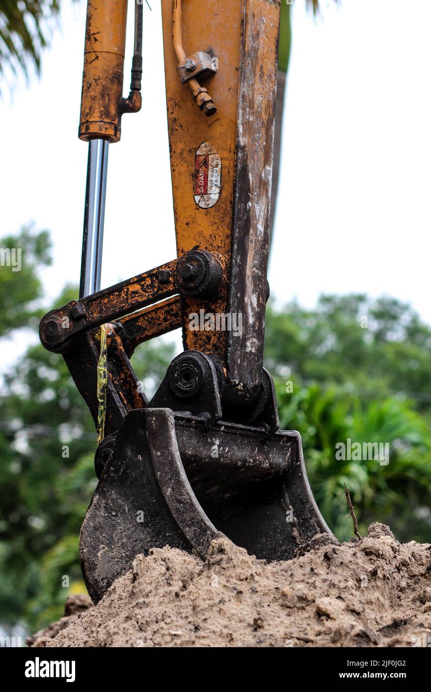 A vertical shot of excavator bucket in the ground Stock Photo - Alamy