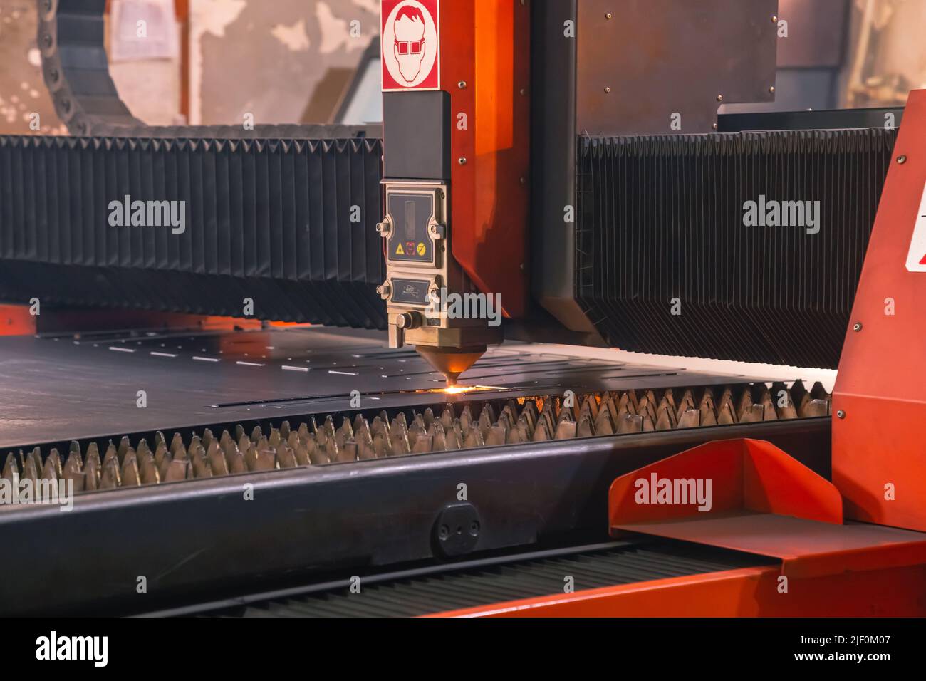 The laser machine is engaged in metal cutting at the factory Stock ...