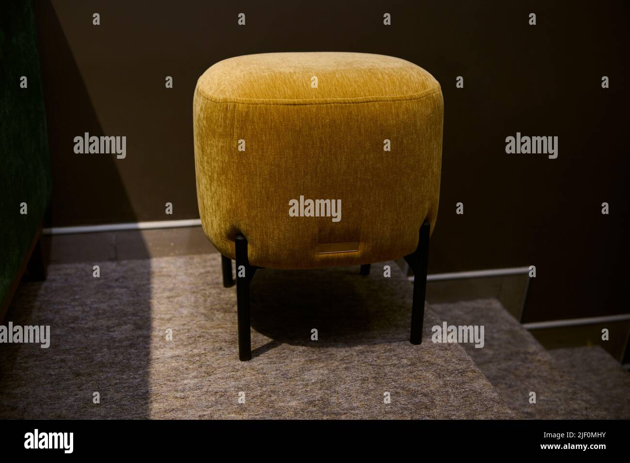 Stylish velour yellow footstool, ottoman in the furniture design ...