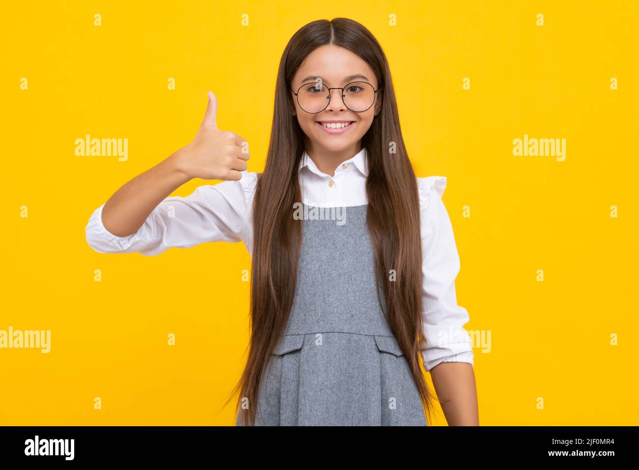 Happy funny teenager child girl show sight thumbs up and good luck ...