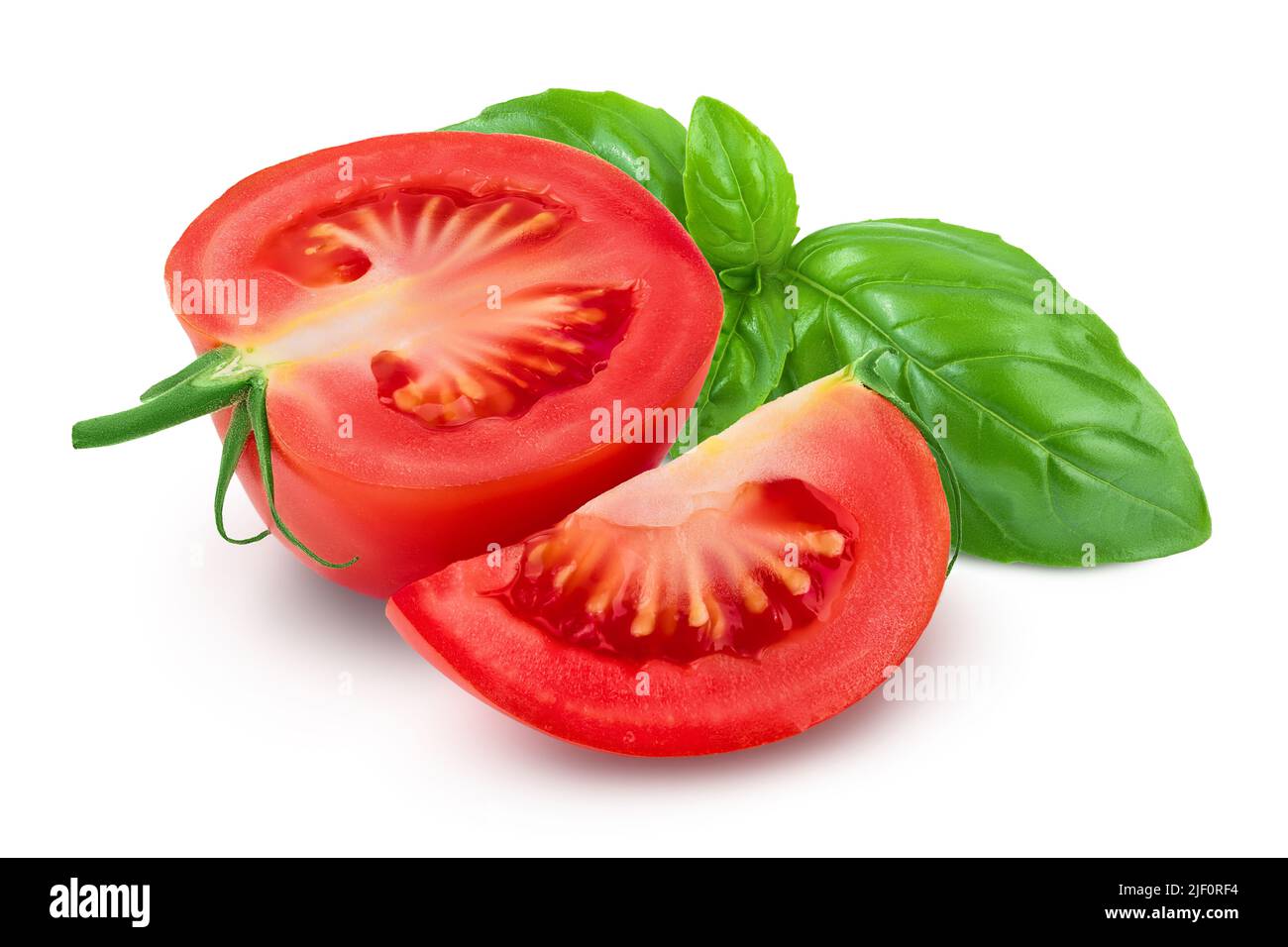 Tomato half and slice isolated on white background with basil leaf and ...