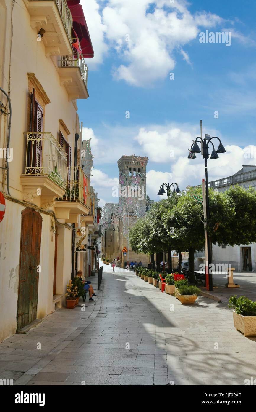 A small street between the old houses of Miglionico, a historic town in ...
