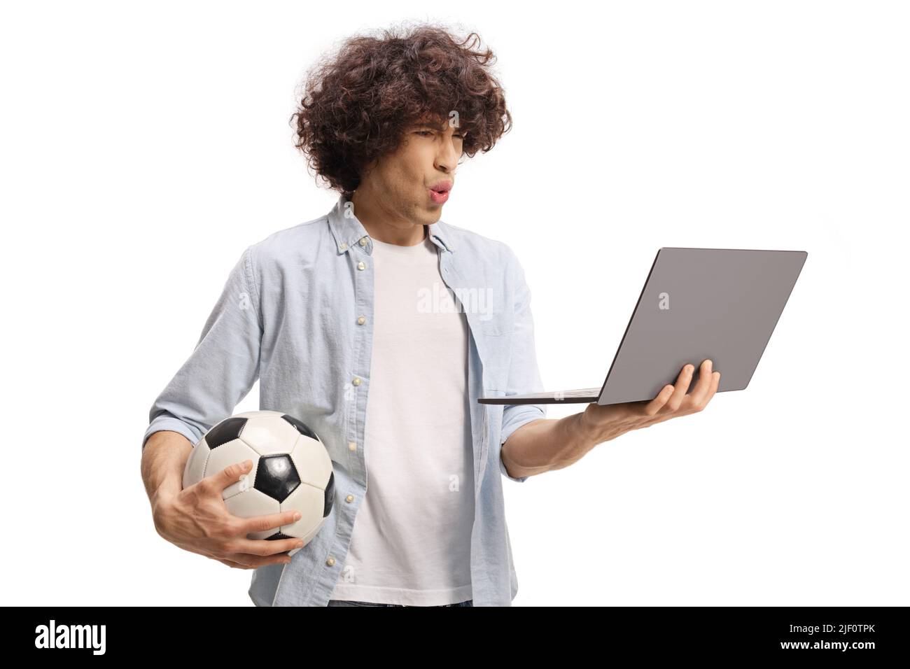 Football fan holding a laptop computer and a ball isolated on white ...