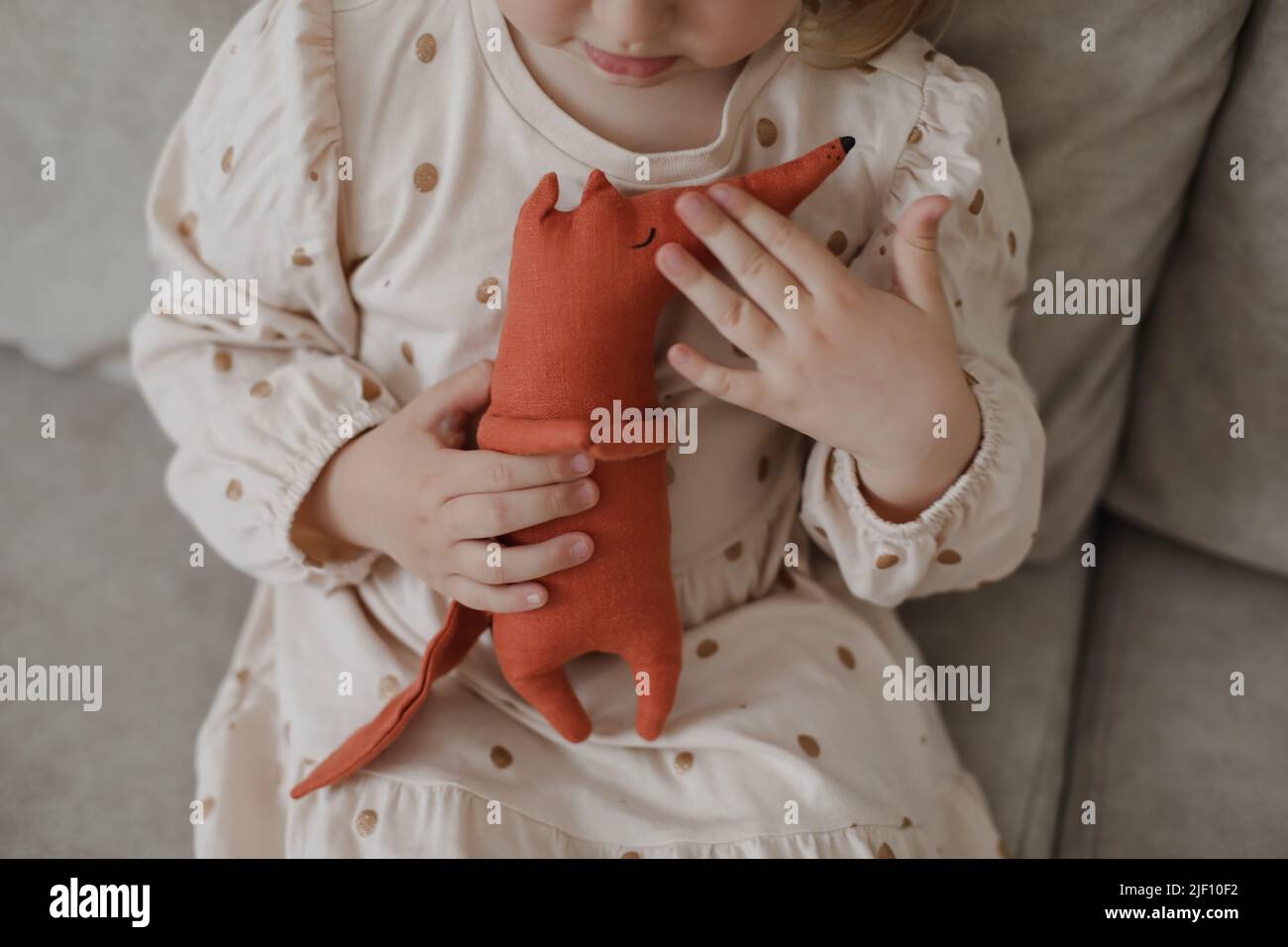 Little girl holding a toy at home. Happy child Stock Photo - Alamy