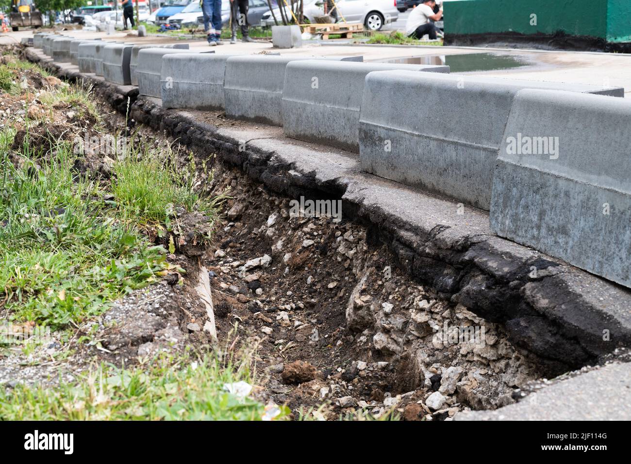 New curbs stand at the edge of the sidewalk. Preparing to repair the ...