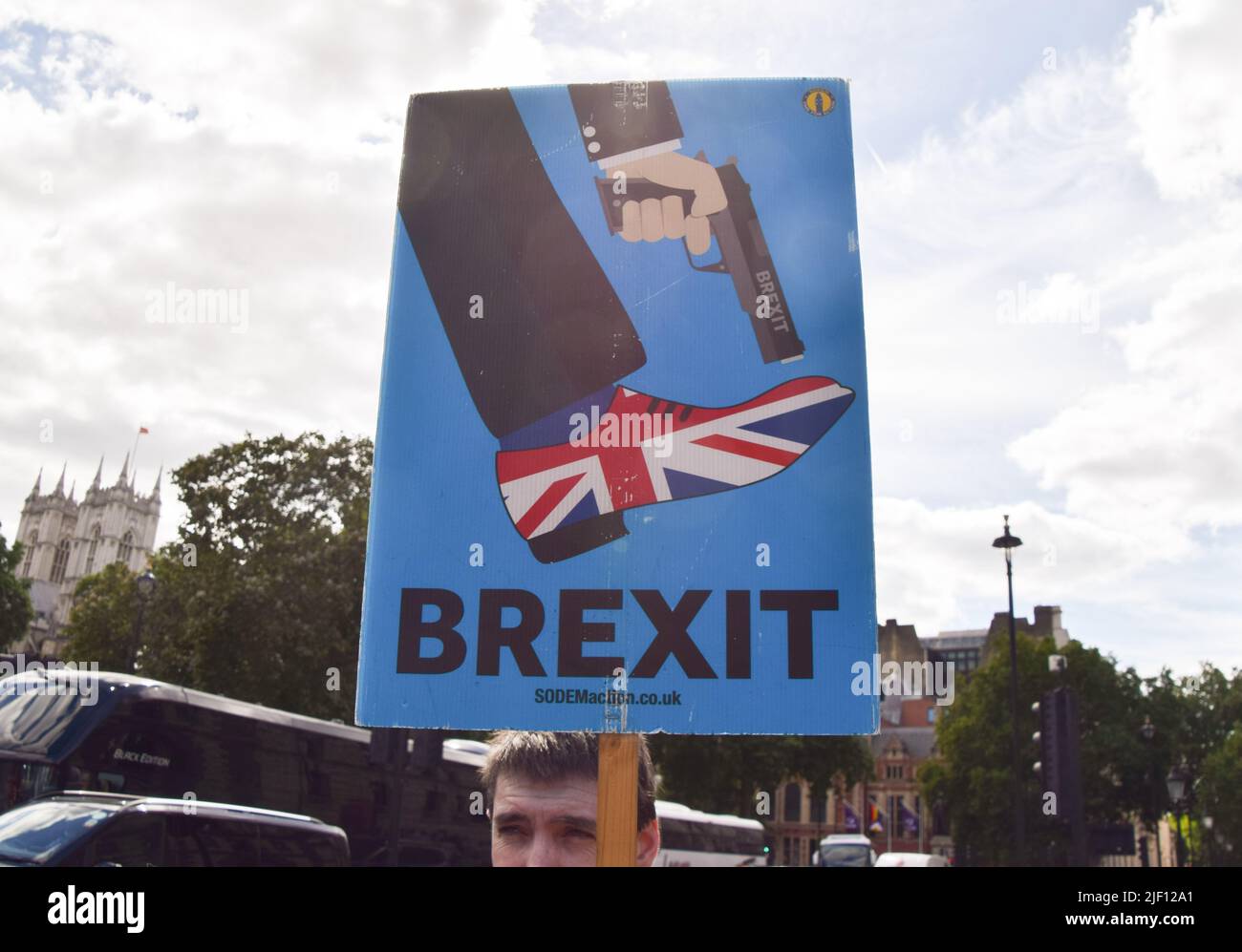 London, England, UK. 28th June, 2022. A protester holds a placard ...