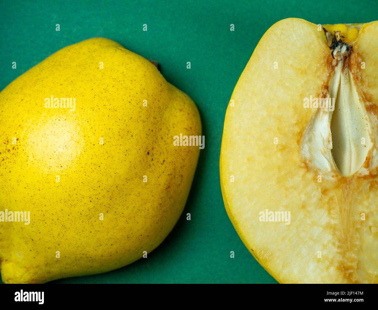 Sliced quince. Juicy fruit on a green background. Ripe useful product ...