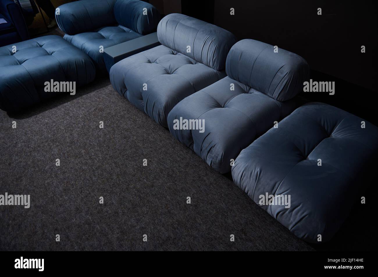 Furniture store showroom interior. Stylish blue sofa in the showroom of ...