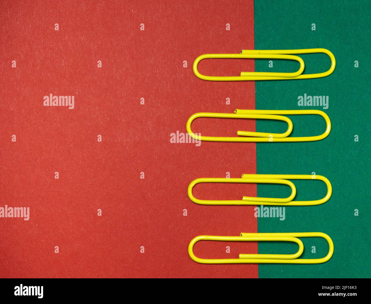 Colored paper clips on paper. Office supplies. Business goods. Colorful ...