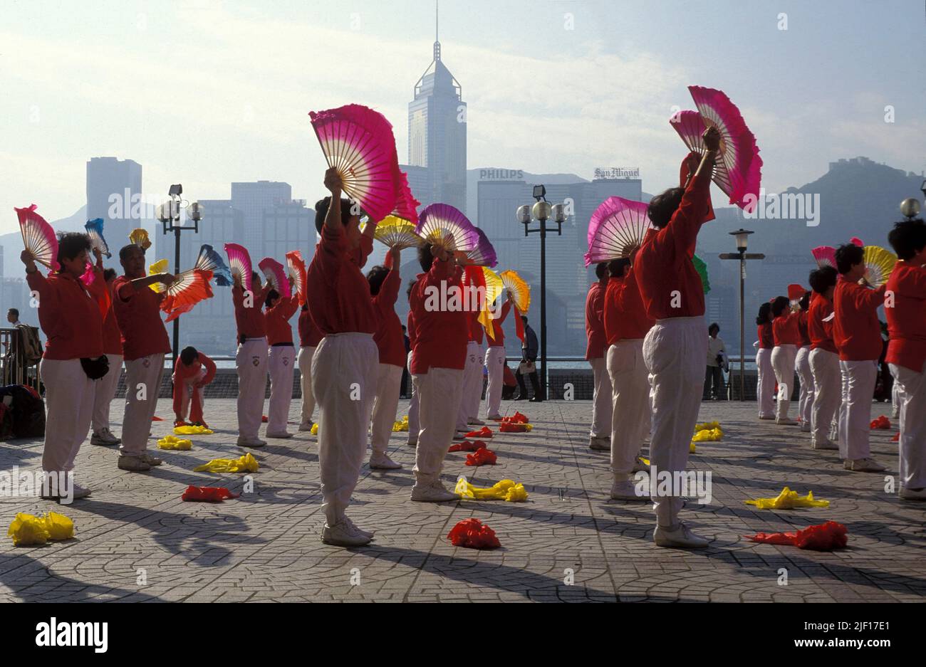 traditional chinese dance at the waterfront of Kowloon in front of the skyline of Hong Kong ...