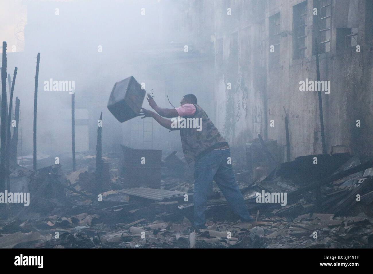 Rio de Janeiro, Brazil. 28th June, 2022. A man looks through damage. A ...