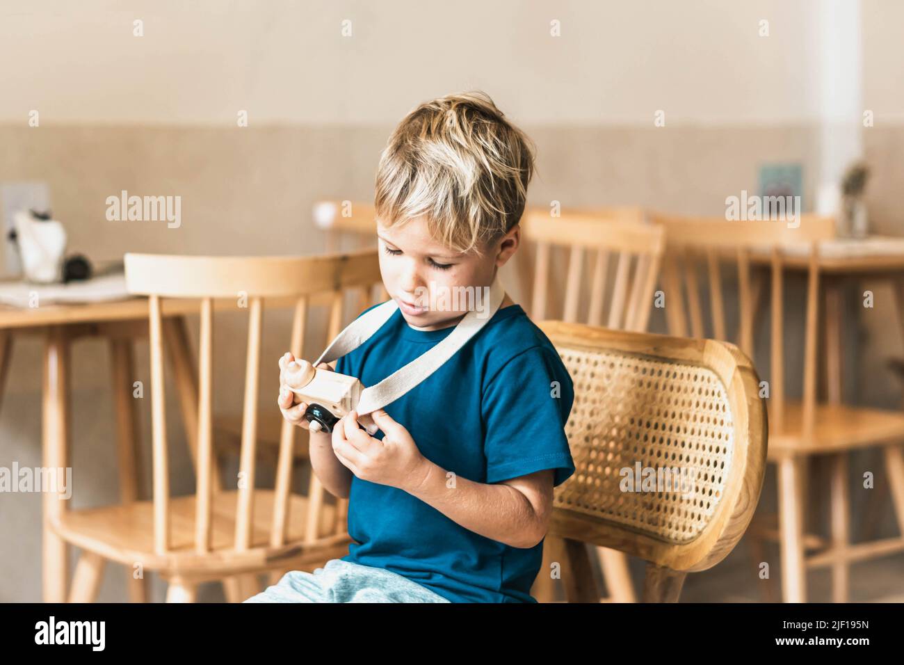 Cute happy smile little boy play handmade wooden photo camera, hold toy ...