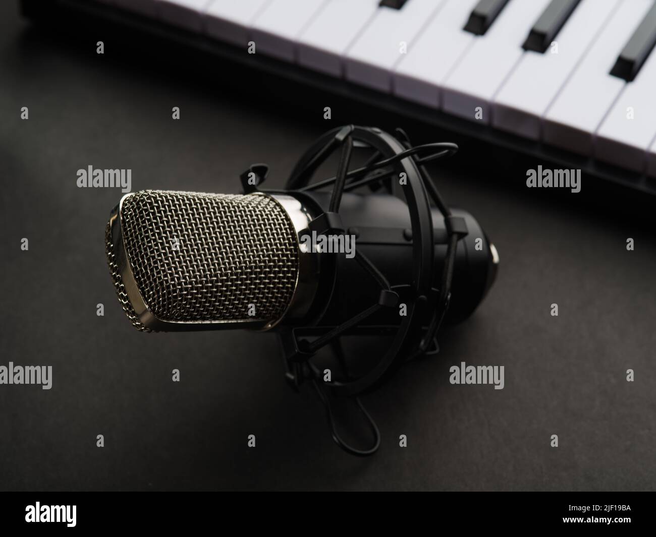 Close-up. Professional microphone and media keyboard on a gray ...