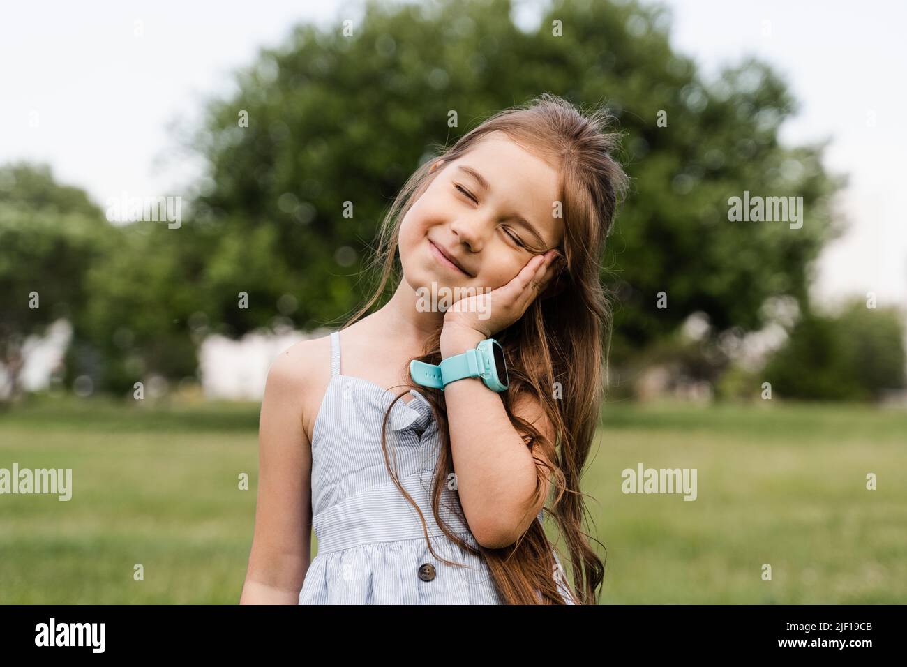 Tender toddler child girl touching her cheek and smile. Adorable kid ...