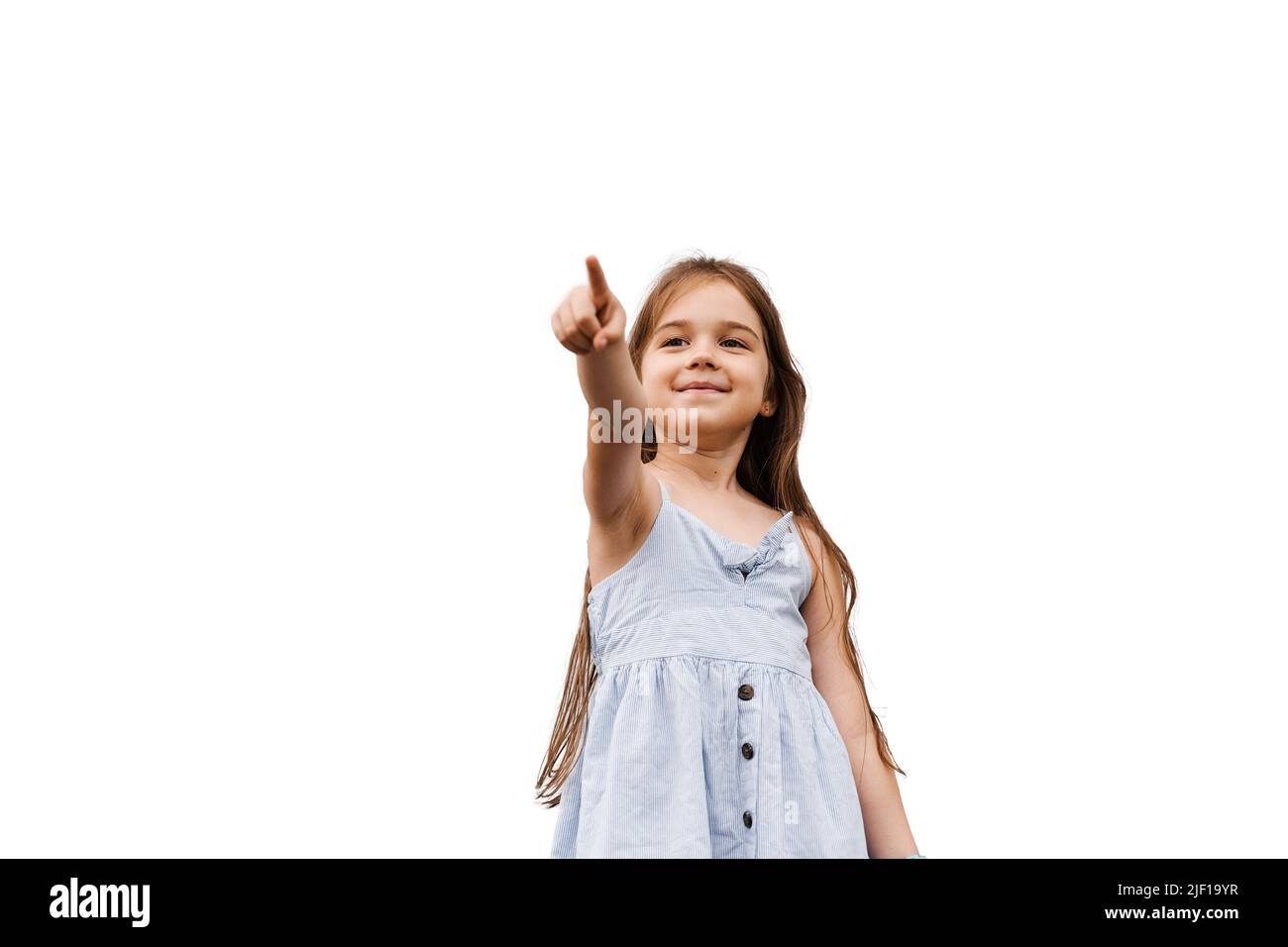 Adorable child girl pointing finger forward on white background with ...