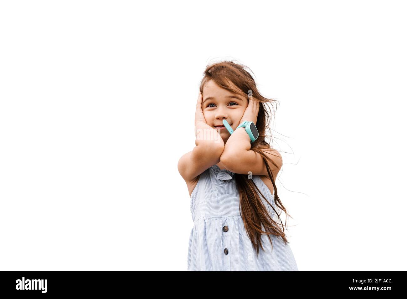 Upset child girl closes her ears because of quarrel her parents. Stressed kid on white ...