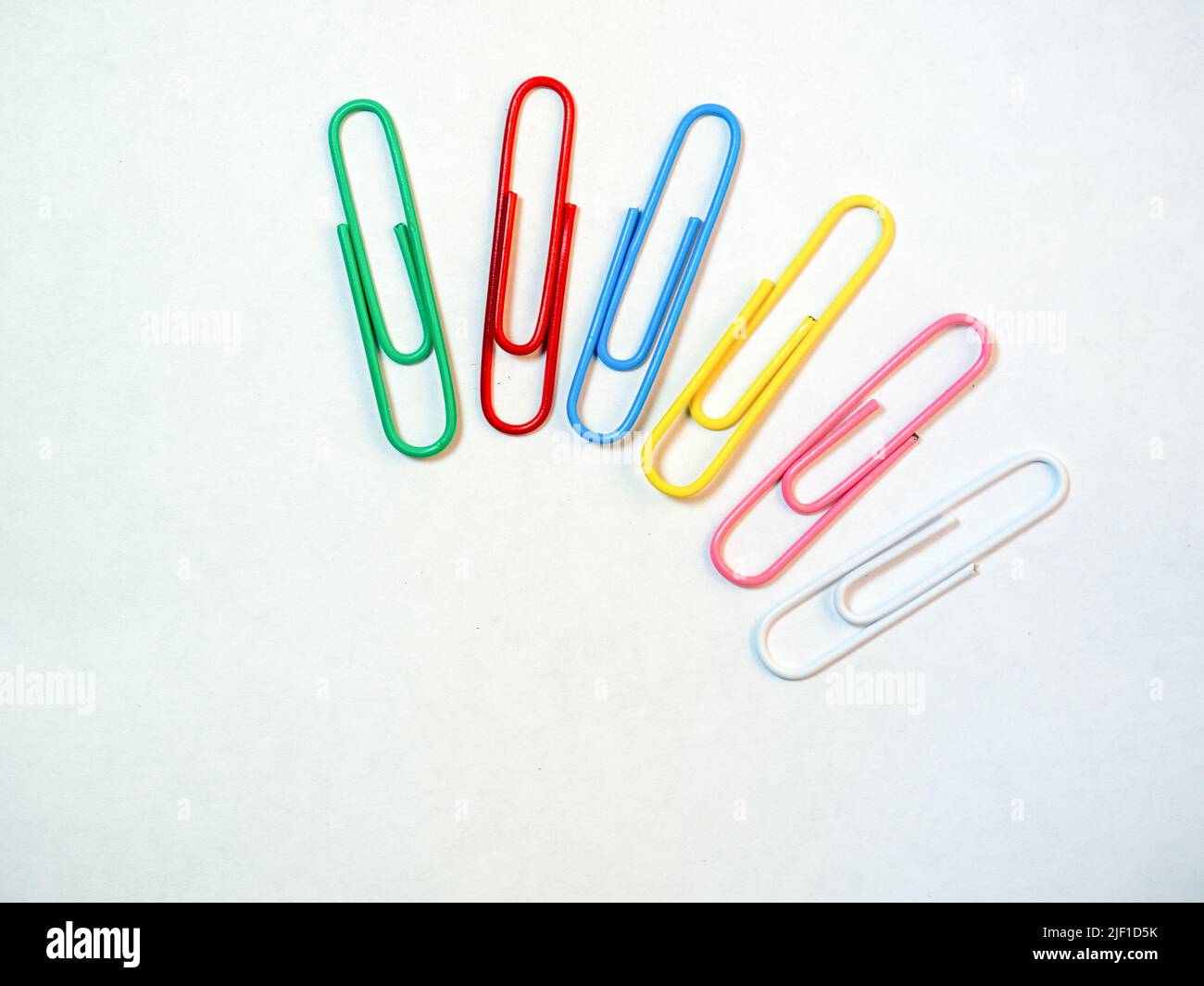 Large multi-colored paper clips. Paperclip of documents. Desktop ...