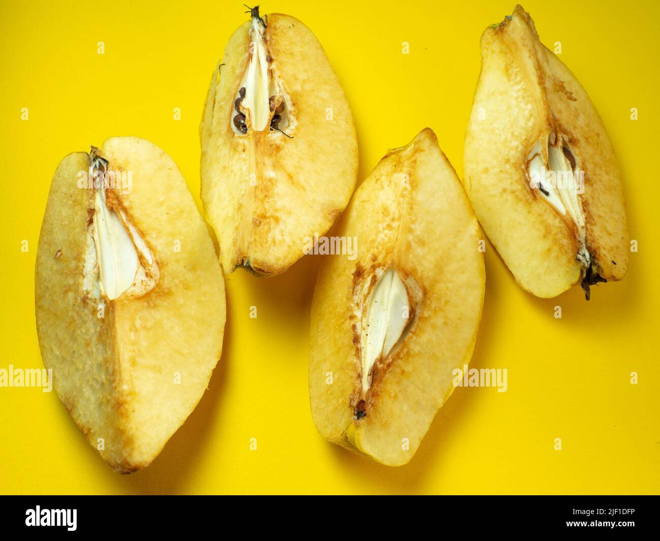 chopped quince. Juicy fruits on a yellow background. Ripe useful ...