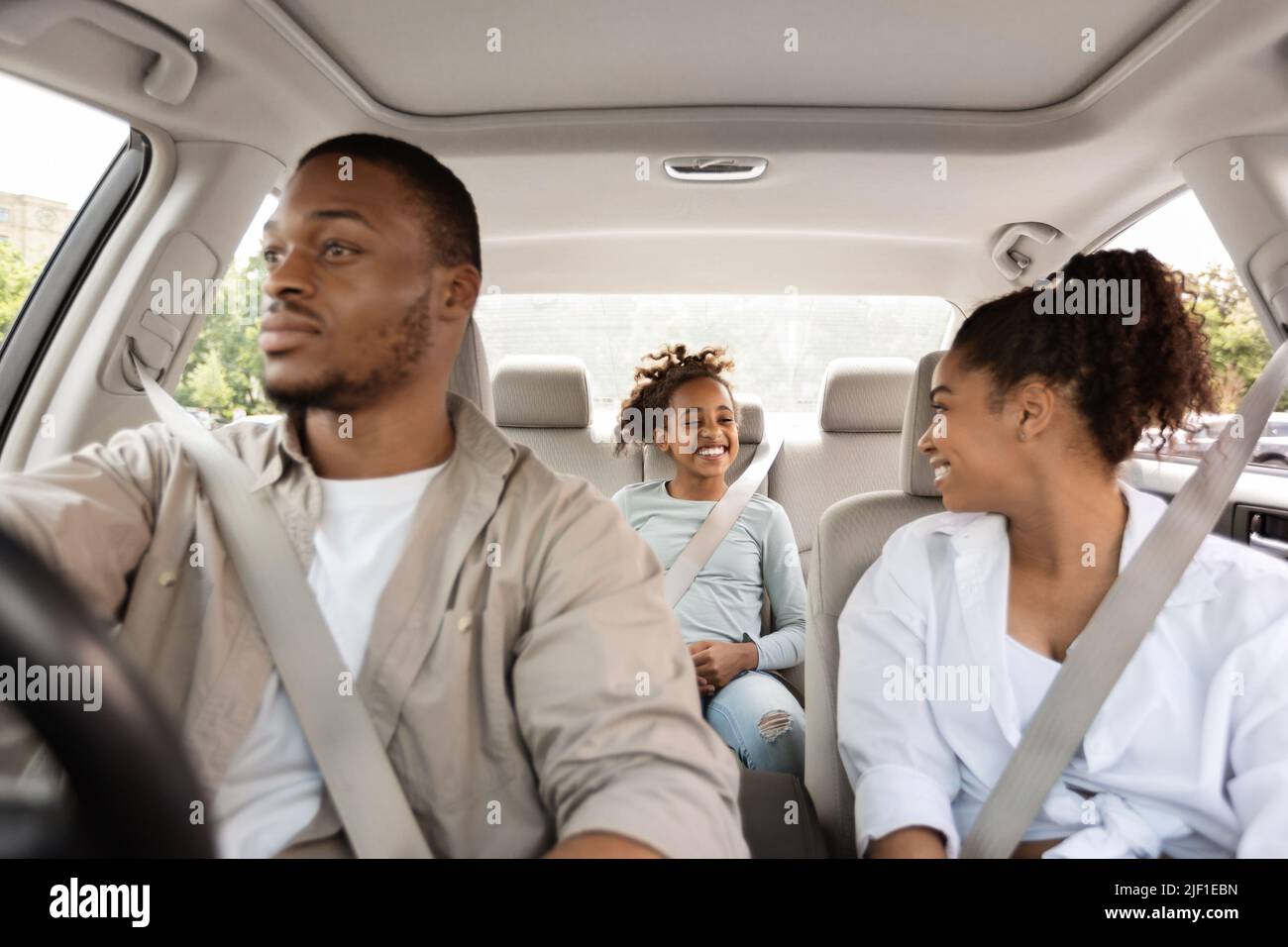 Happy African American Family Driving New Automobile Enjoying Road Trip ...
