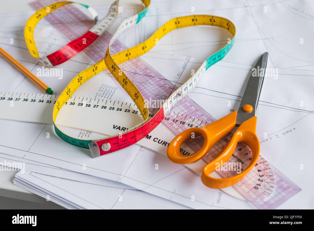 Sewing items and seamstress tools. Tailoring scissors, measuring tape, spools of thread, rulers ...