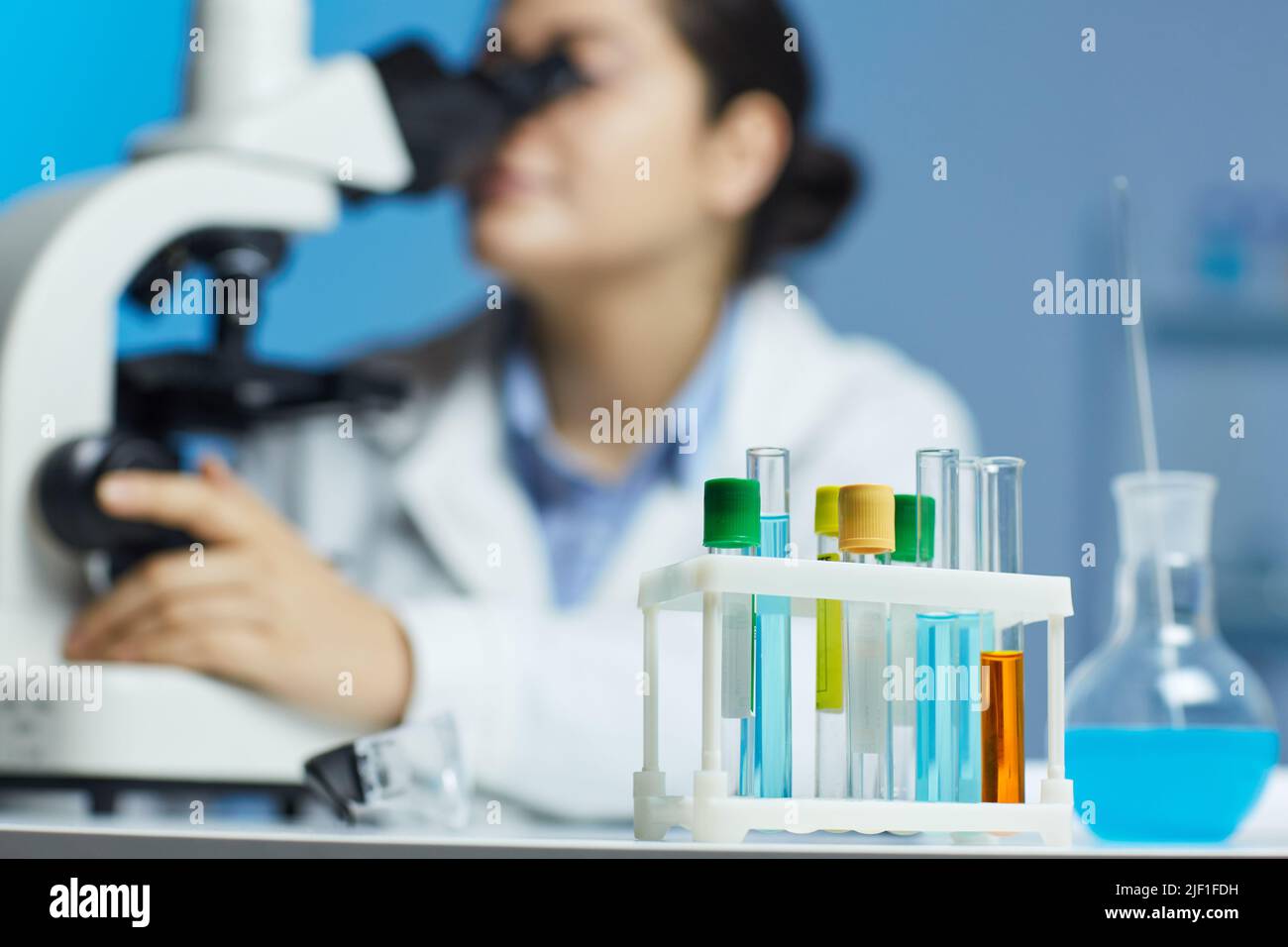 Close-up of test tubes filled with colorful medical samples placed in ...