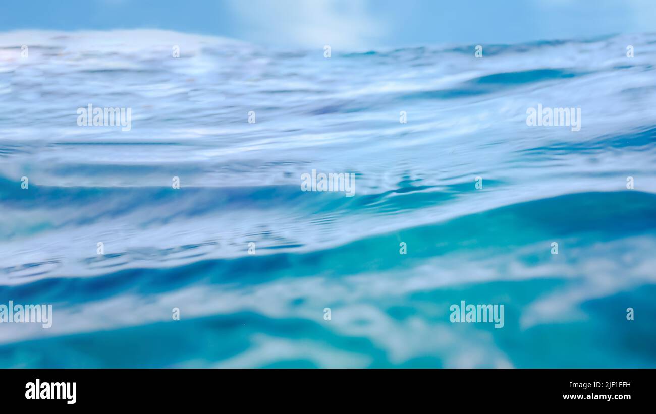 A low angle view of the Pacific ocean blue water in Maui Hawaii for a ...